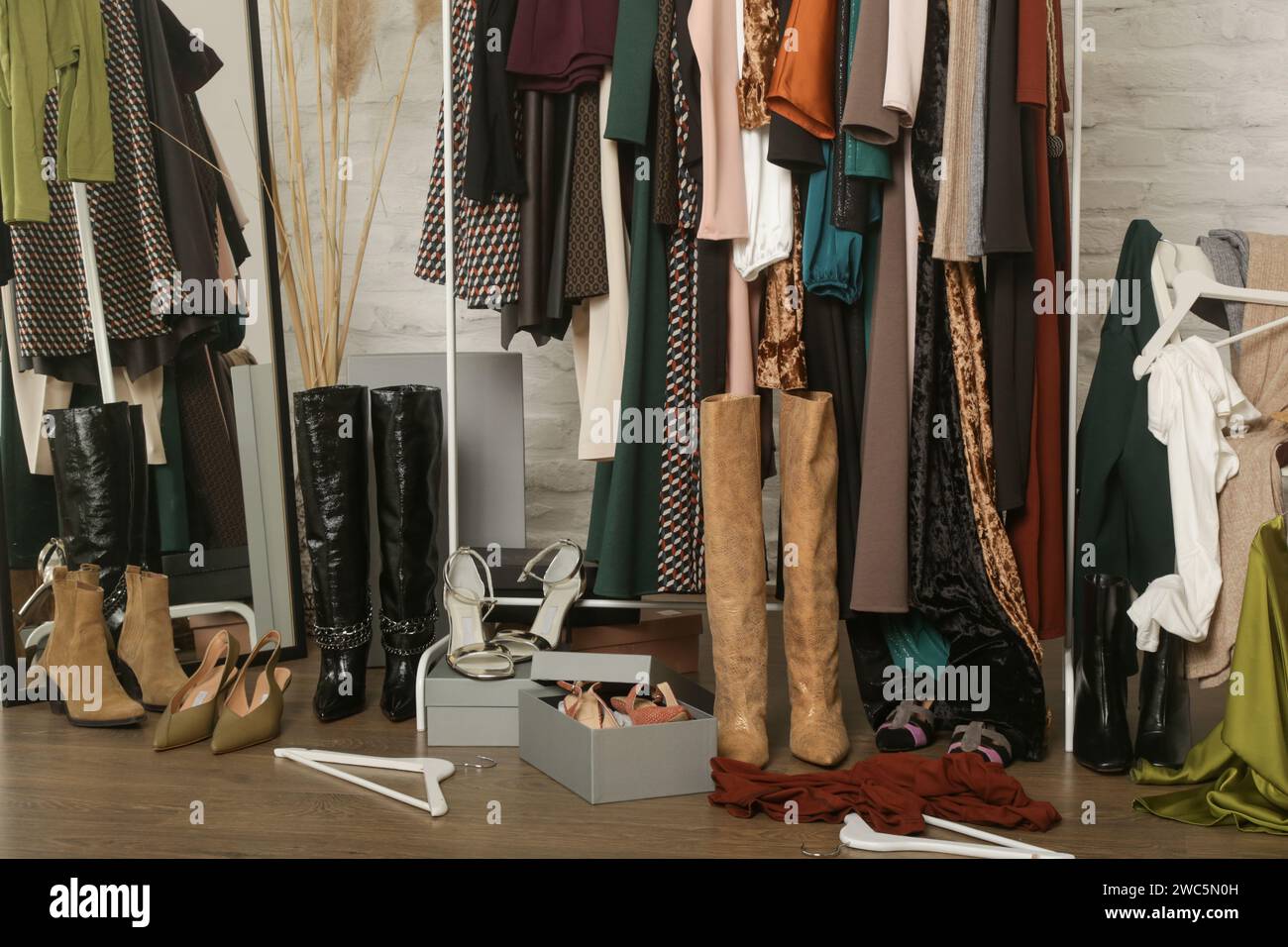 Untidy cluttered woman wardrobe with stylish clothes and accessories ...