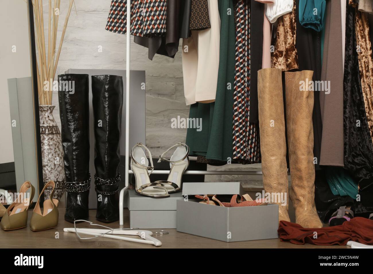 Untidy cluttered woman wardrobe with stylish clothes and accessories ...