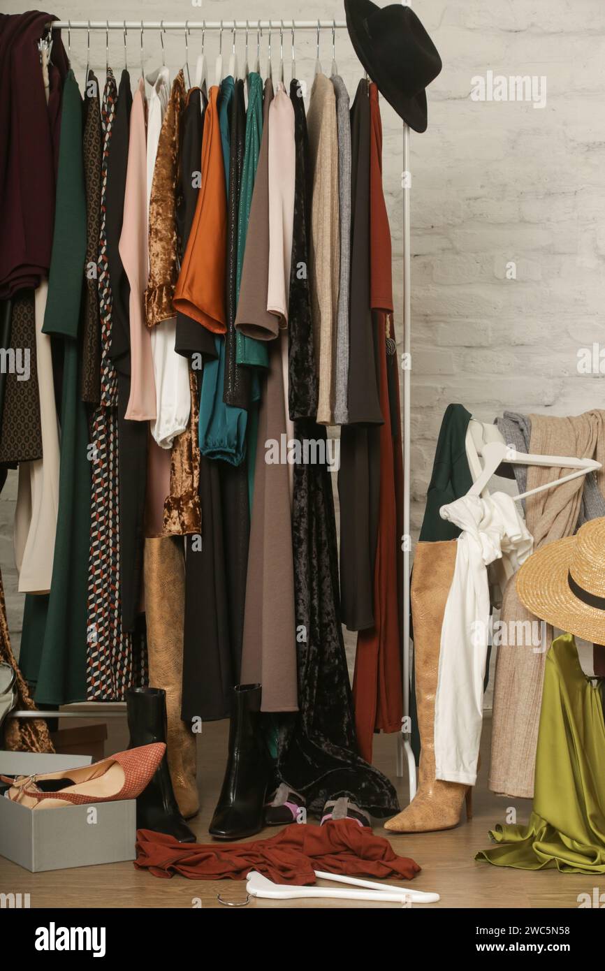 Untidy cluttered woman wardrobe with stylish clothes and accessories ...
