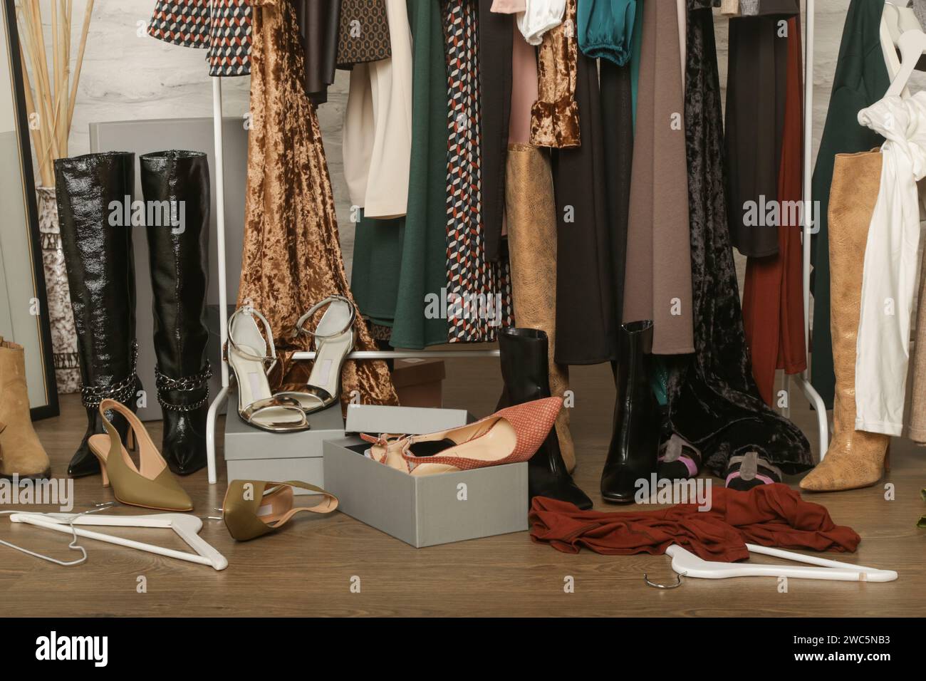 Untidy cluttered woman wardrobe with stylish clothes and accessories ...