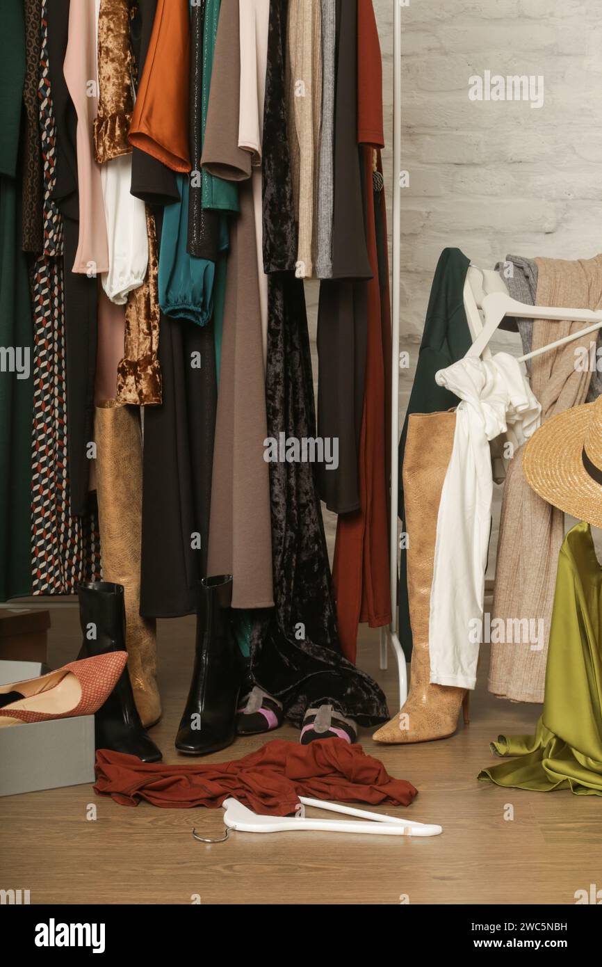 Untidy cluttered woman wardrobe with stylish clothes and accessories ...