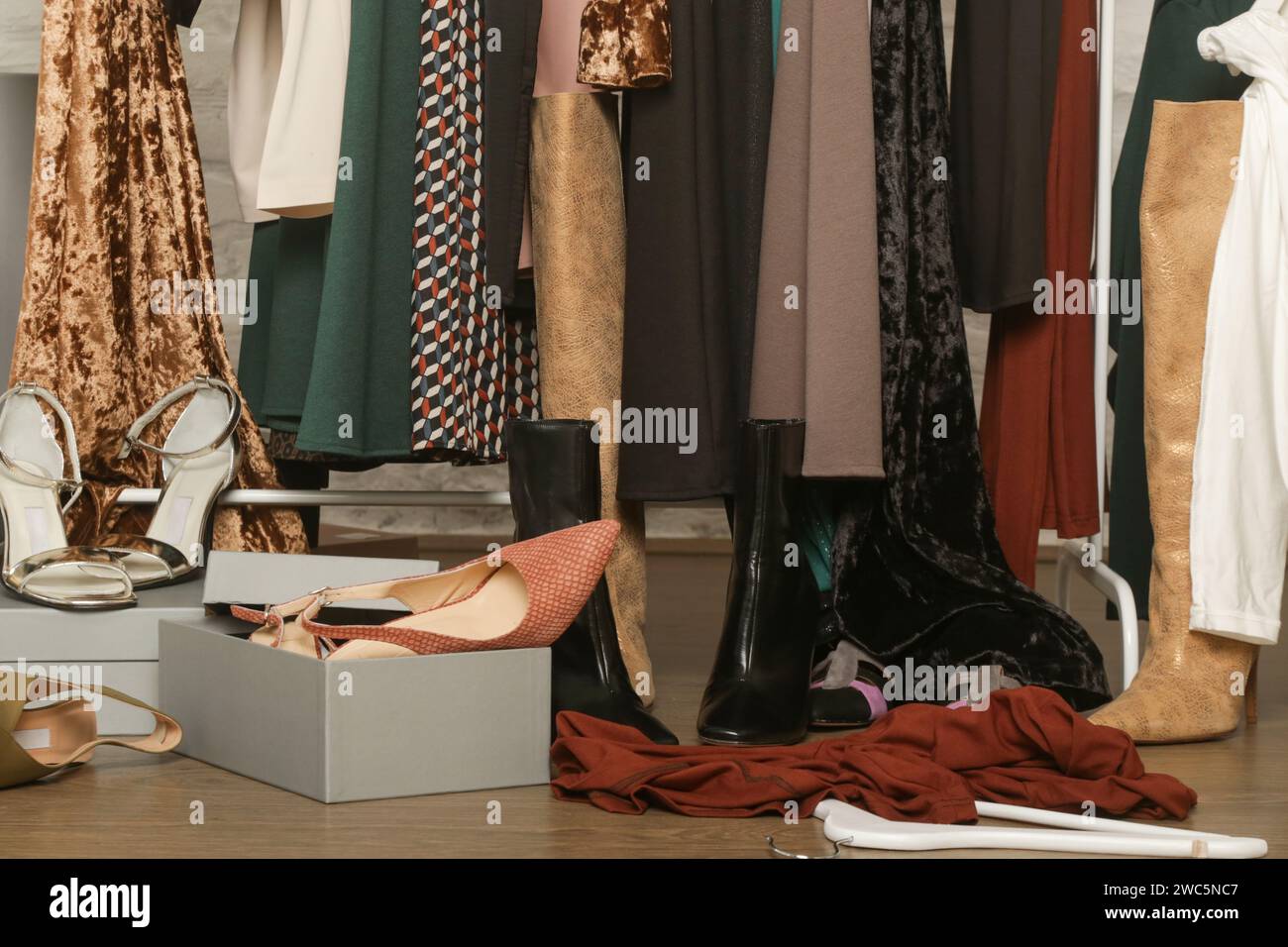 Untidy cluttered woman wardrobe with stylish clothes and accessories ...