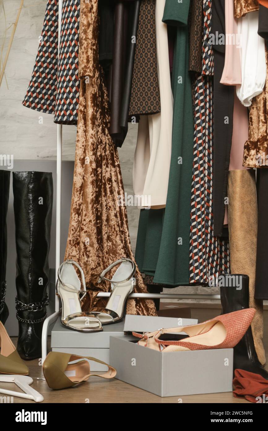 Untidy cluttered woman wardrobe with stylish clothes and accessories ...
