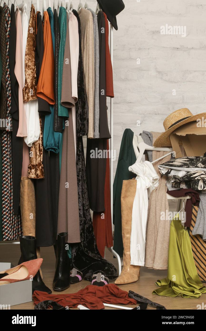 Untidy cluttered woman wardrobe with stylish clothes and accessories ...