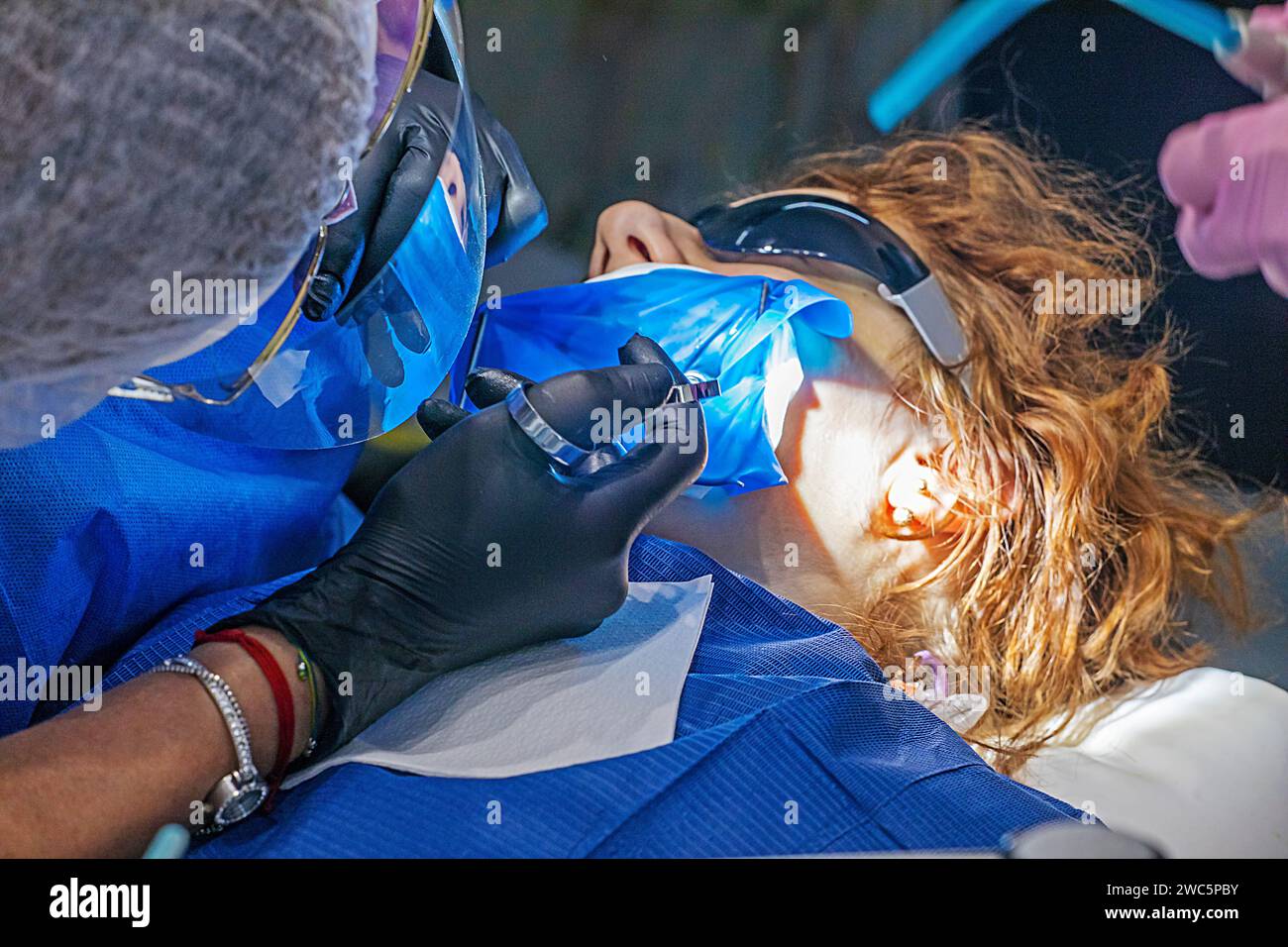 Dentist fixes patient's diseased tooth with instruments Stock Photo - Alamy