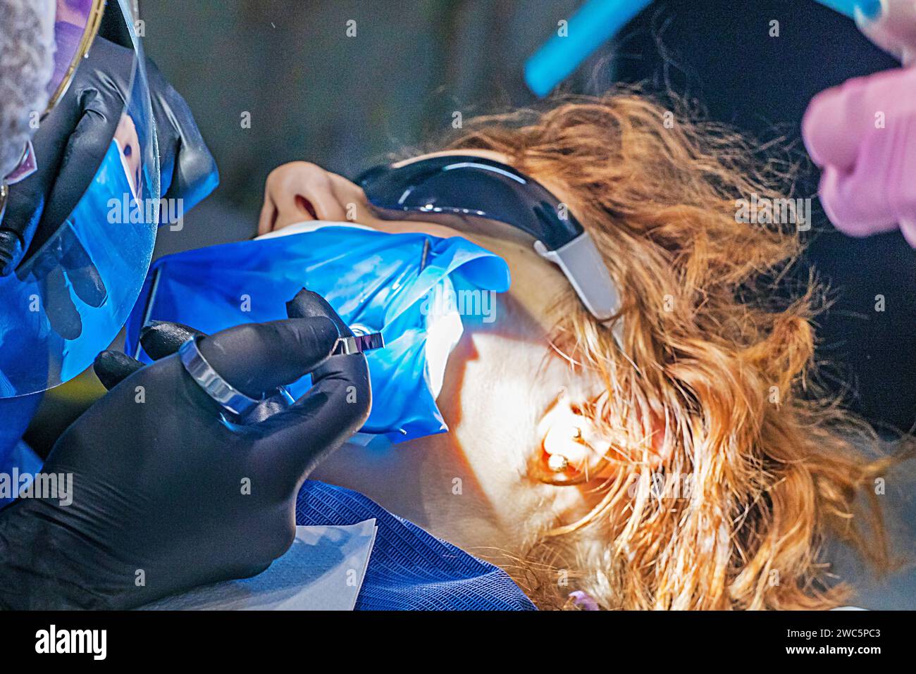 Dentist fixes patient's diseased tooth with instruments Stock Photo - Alamy
