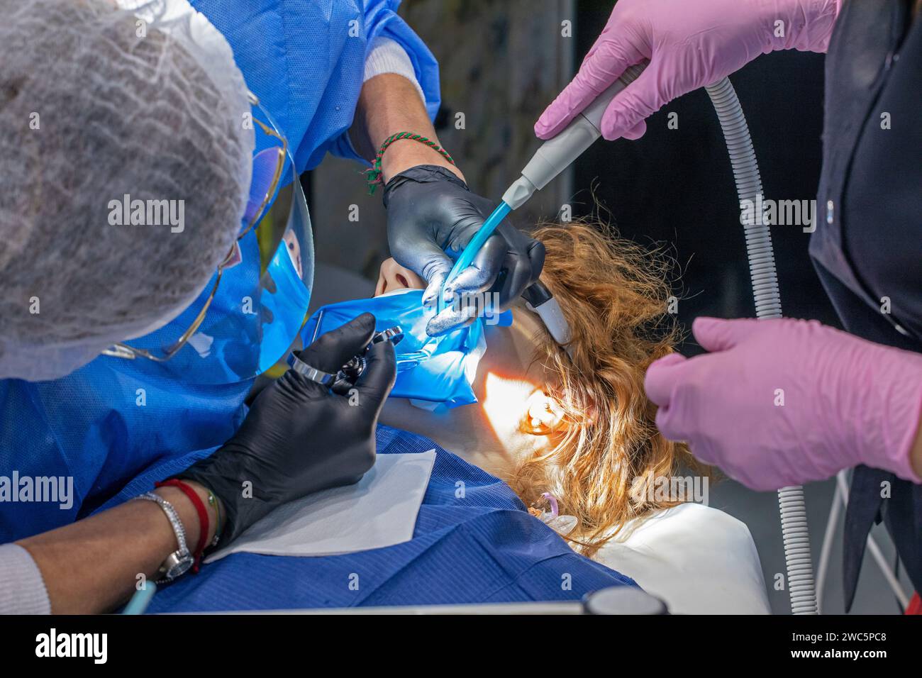 Dentist fixes patient's diseased tooth with instruments Stock Photo - Alamy