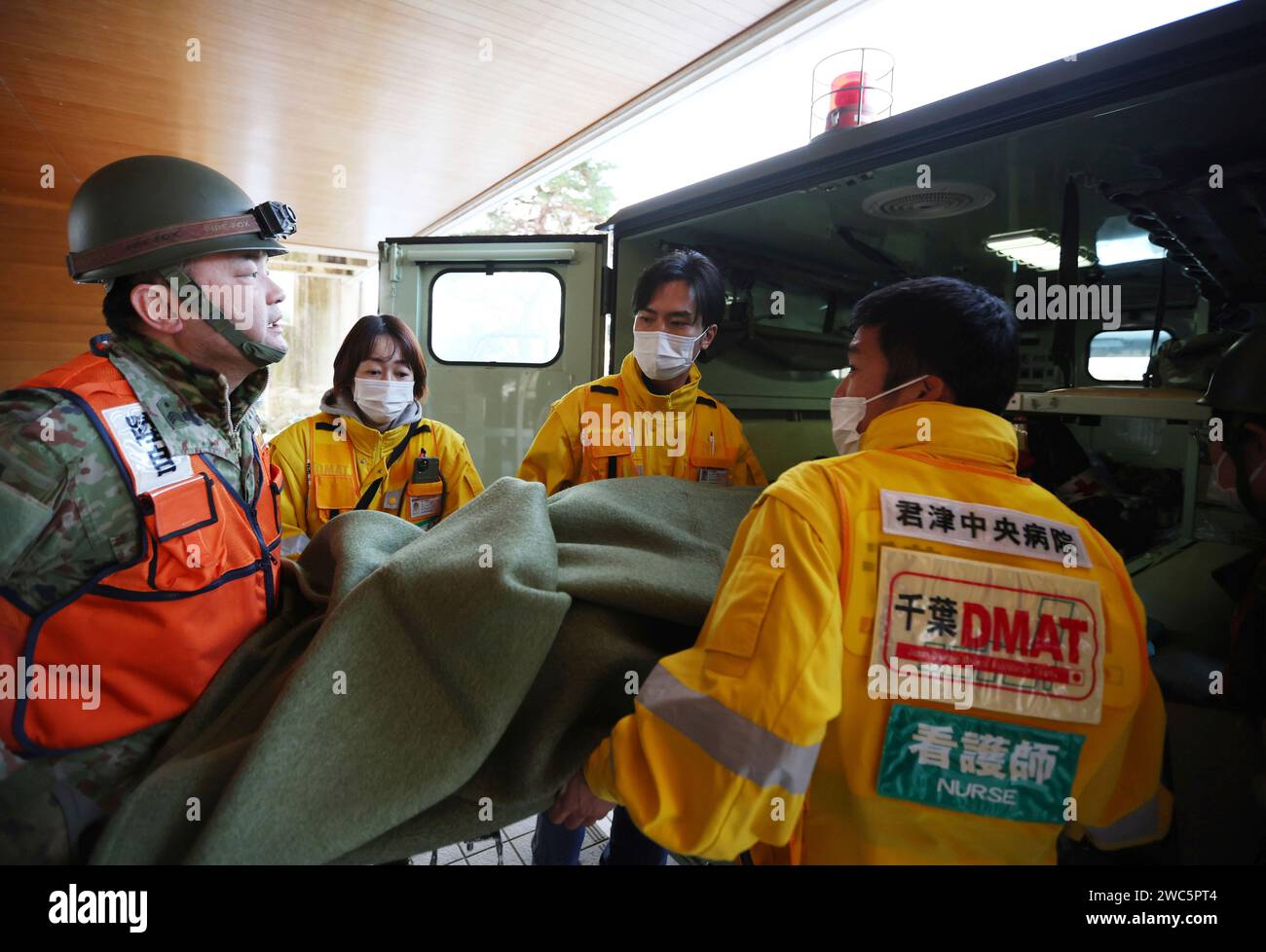 DMAT (Disaster Medical Assistance Team) and Japan Self-Defense Force members transport patients ...