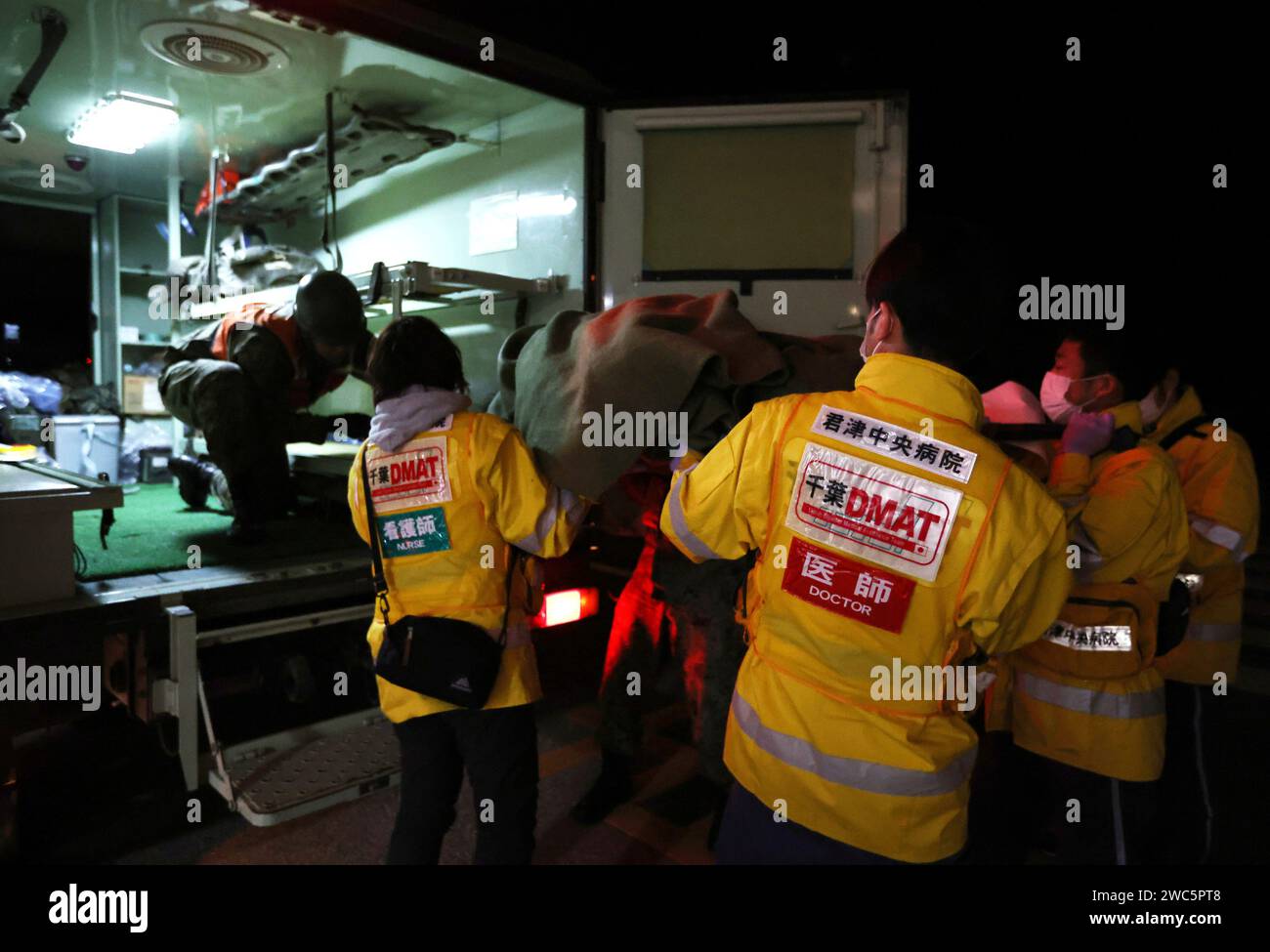 DMAT (Disaster Medical Assistance Team) and Japan Self-Defense Force members transport patients ...
