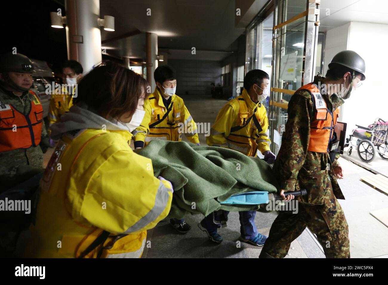 DMAT (Disaster Medical Assistance Team) and Japan Self-Defense Force members transport patients ...