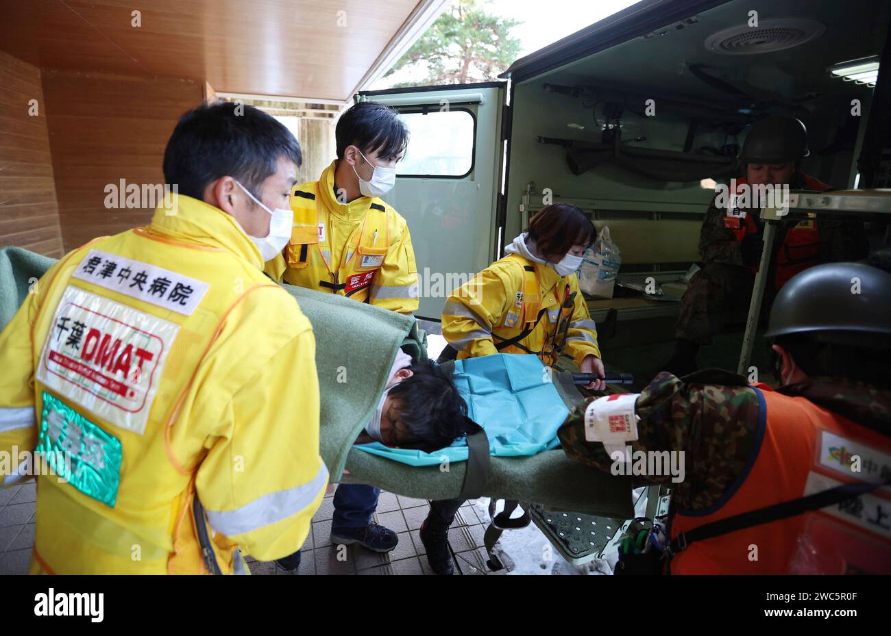 DMAT (Disaster Medical Assistance Team) and Japan Self-Defense Force members transport patients ...