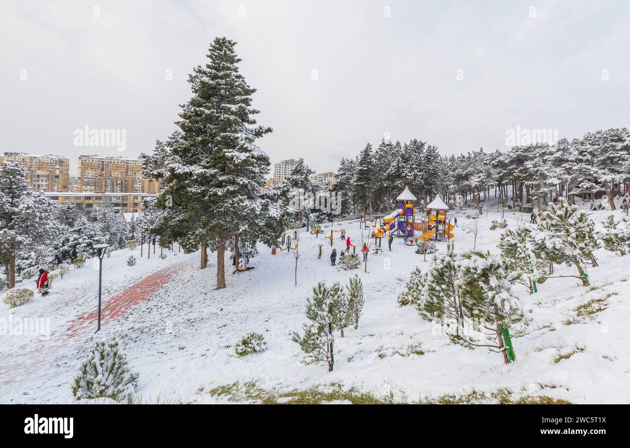 BAKU, AZERBAIJAN - JANUARY 31 2024: A park covered with snow in Baku in ...