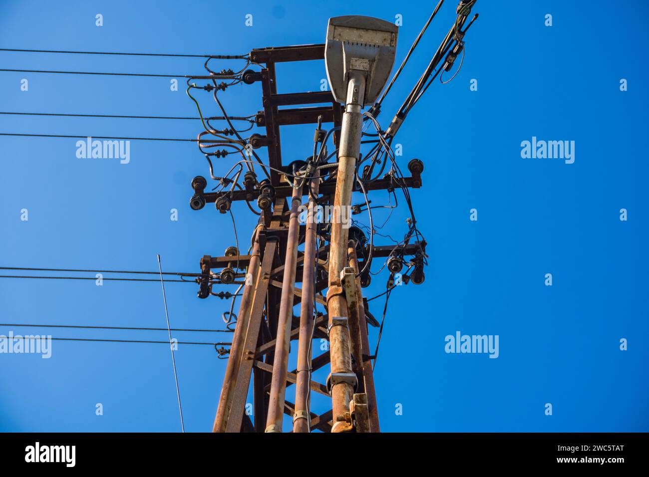 Electric poles and power lines and communication lines against the blue ...