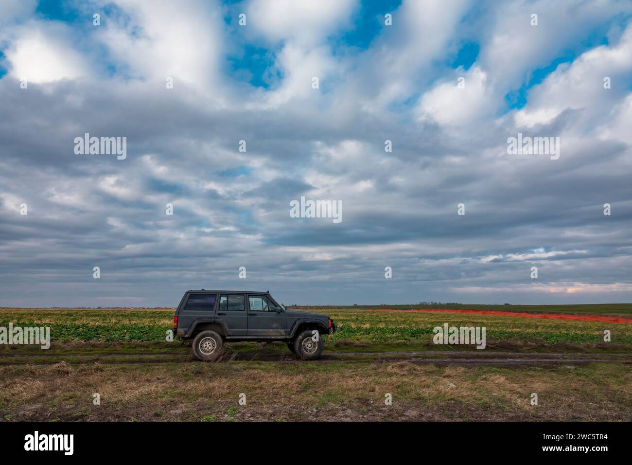 Offroad 4x4 car of unidentifiable brand on the rural dirt road with ...