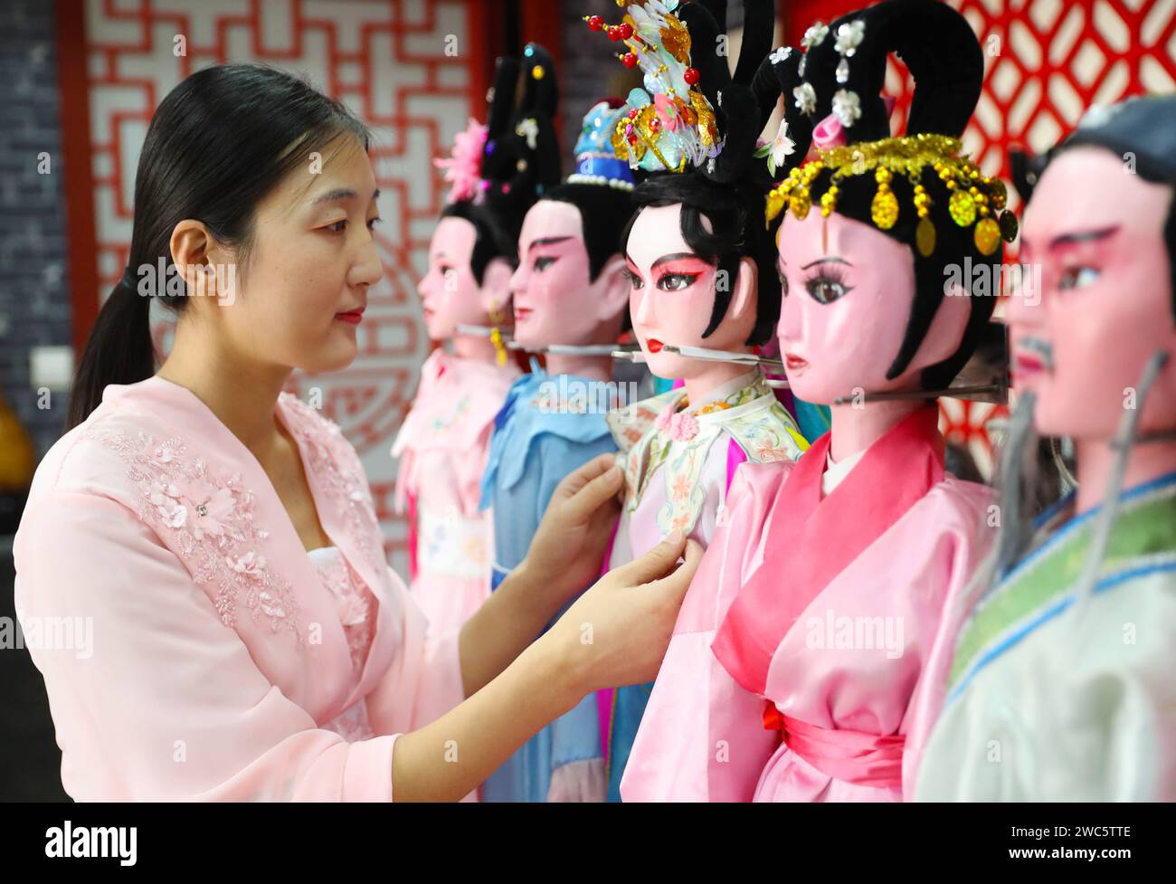 LAIXI, CHINA - JANUARY 14, 2024 - Actors of the Puppet Art Troupe tidy ...