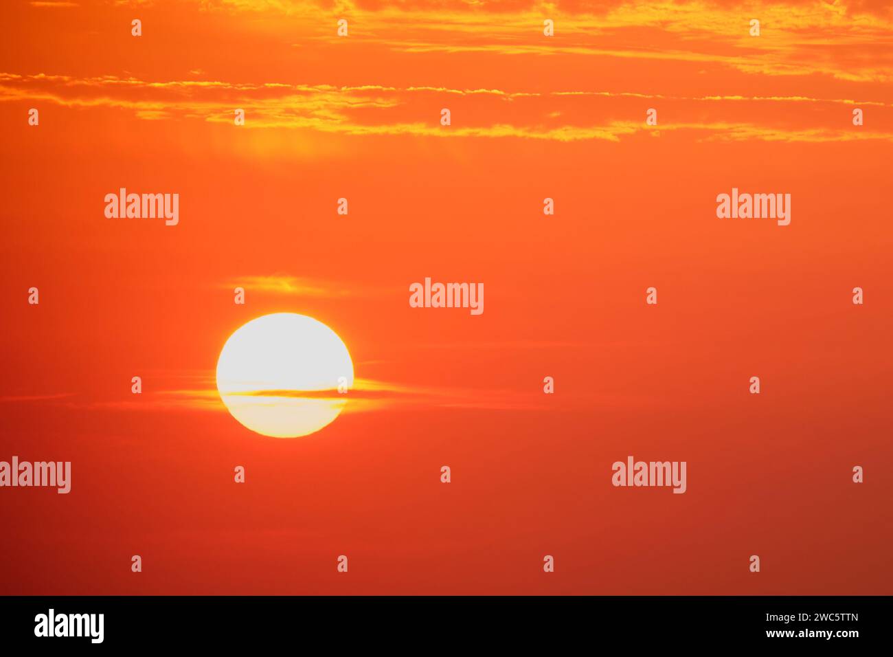 As dawn breaks, the sky transitions from darkness to a bright blue ...