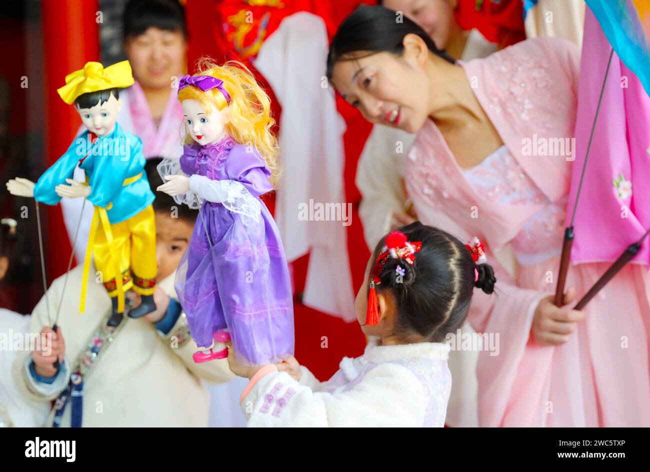 LAIXI, CHINA - JANUARY 14, 2024 - A child interacts with a puppet in ...