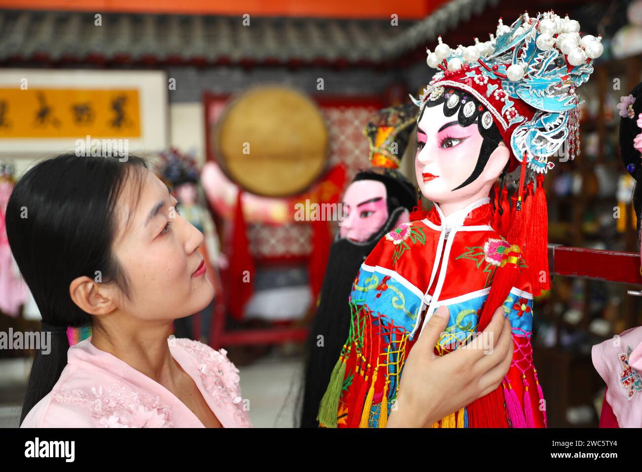 LAIXI, CHINA - JANUARY 14, 2024 - Actors of the Puppet Art Troupe tidy ...