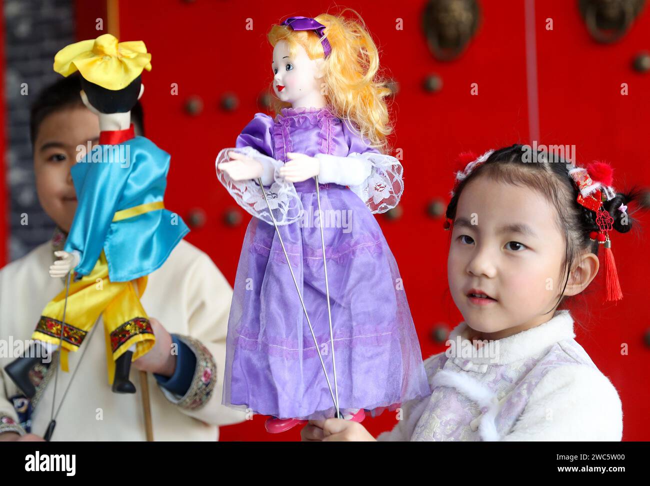LAIXI, CHINA - JANUARY 14, 2024 - A child interacts with a puppet in ...