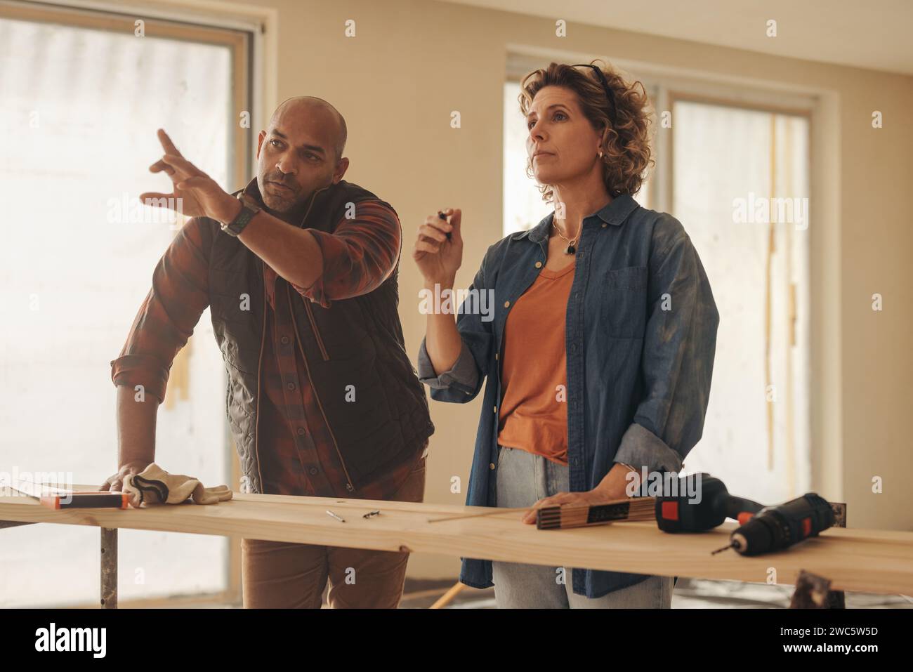 Homeowning couple collaborating on a home renovation project ...