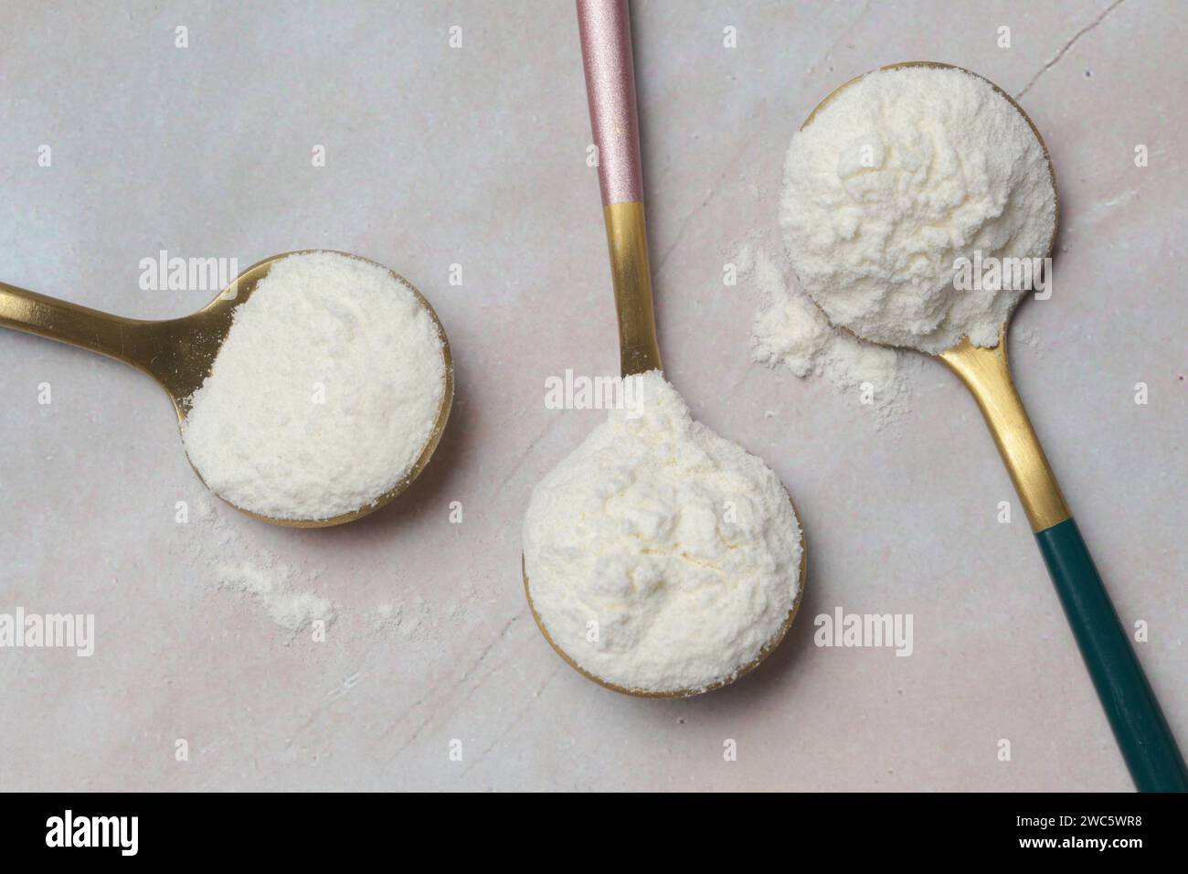White powder in the spoon. Collagen protein powder or wheat flour ...