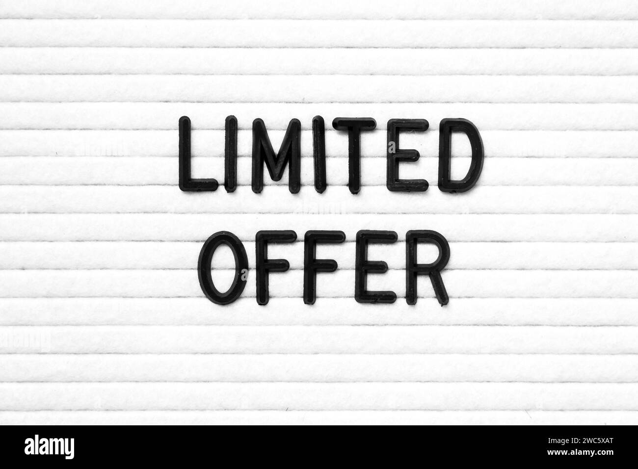 Black color letter in word limited offer on white felt board background ...