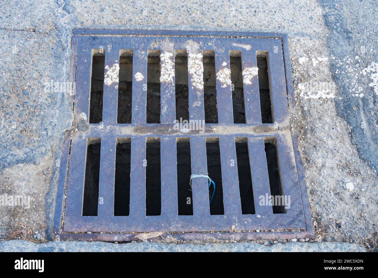 Cast-iron manhole of the storm sewer system on the road in front of the ...