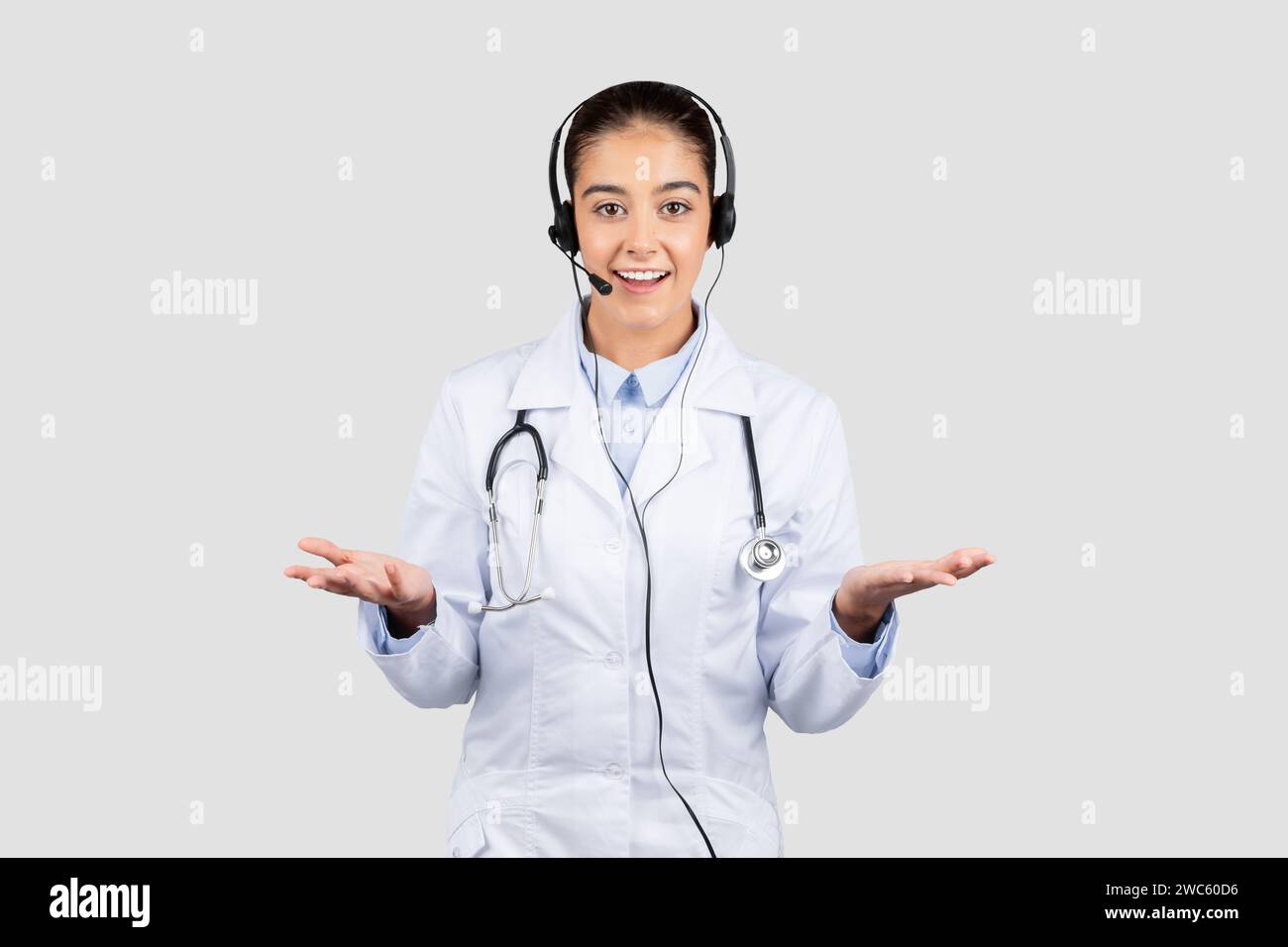 An approachable european doctor wearing a headset and a white lab coat ...