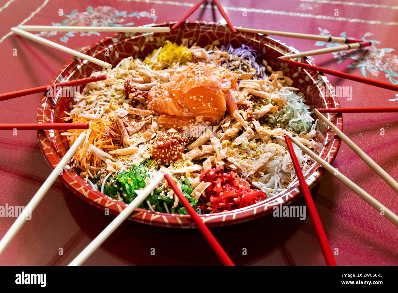 Serving of yusheng or yee sang with raw salmon belly during Chinese New ...
