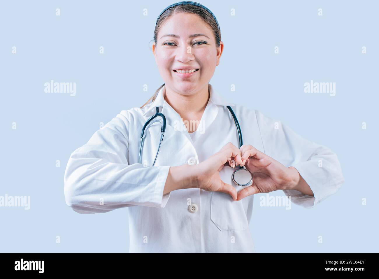 Smiling doctor making heart shape on isolated background. Friendly ...