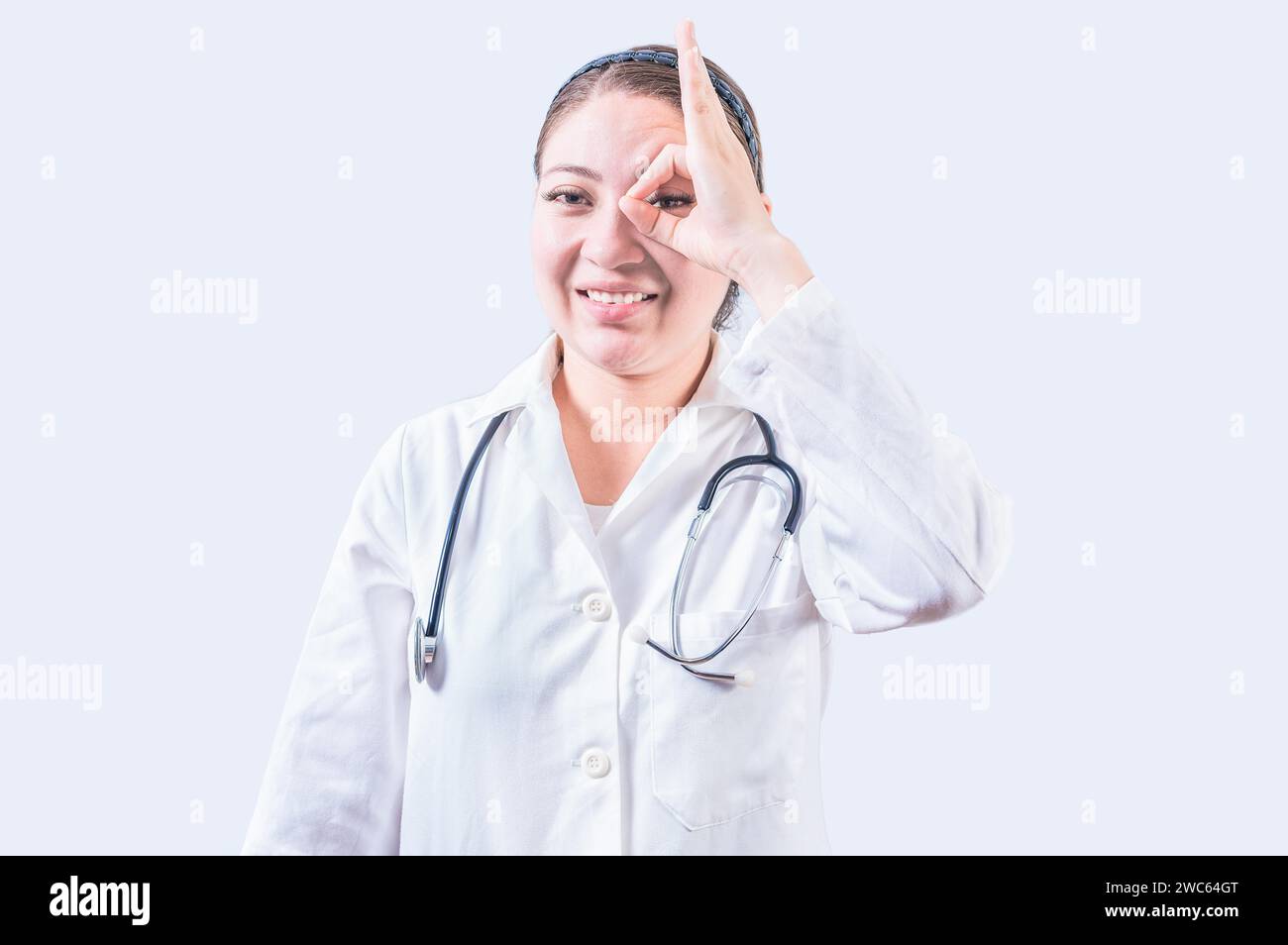Cheerful female doctor gesturing approval isolated. Young female doctor ...