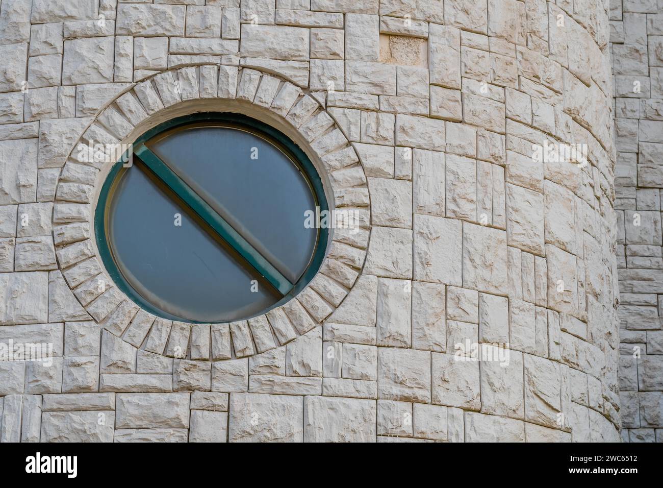 Exterior view of round window in white brick facade Stock Photo - Alamy