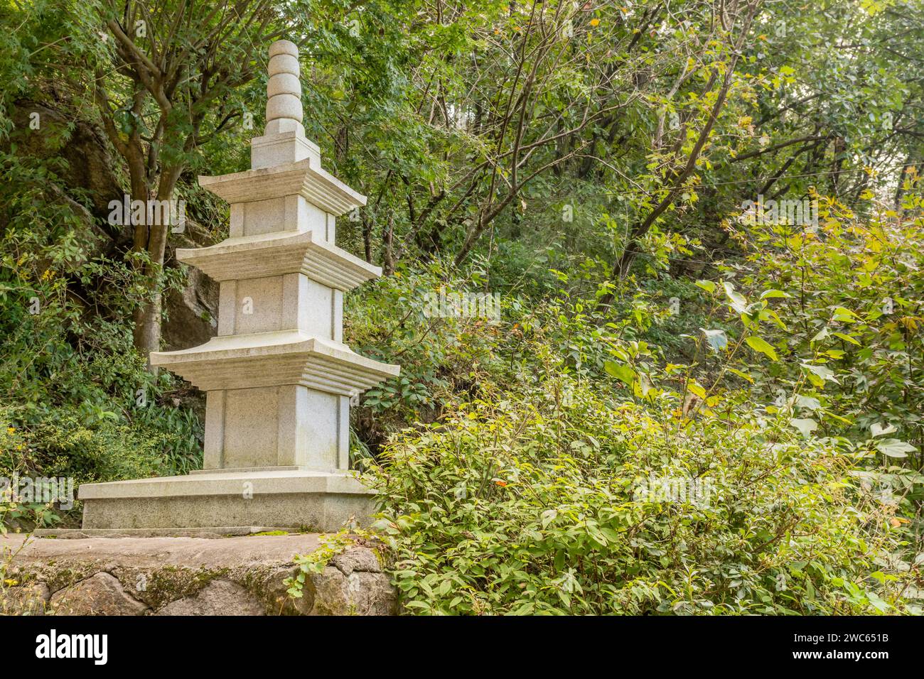 Concrete three story pagoda on concrete plinth in wilderness park Stock ...