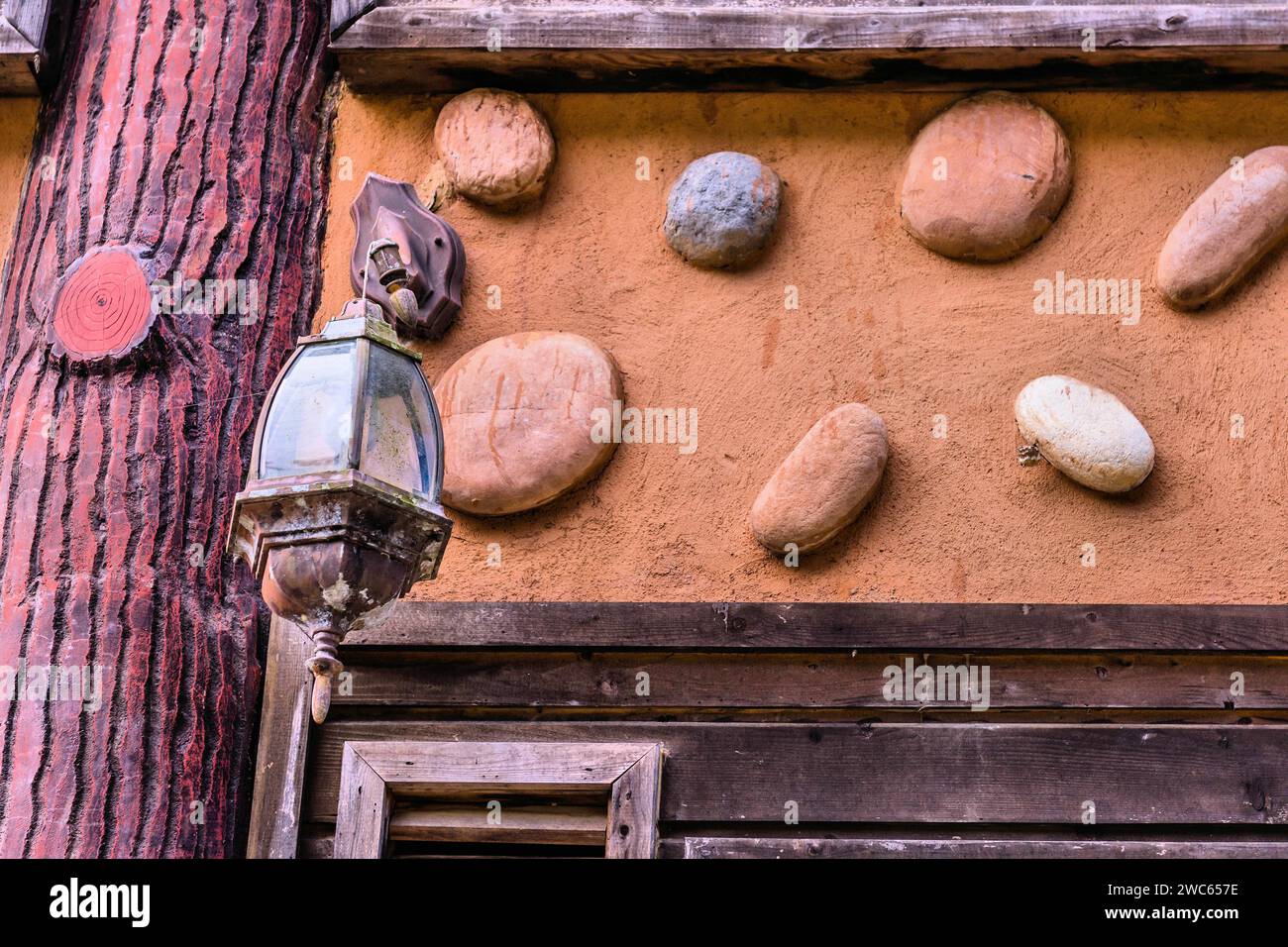 Old dirty broken exterior light hanging on wall of abandoned building ...