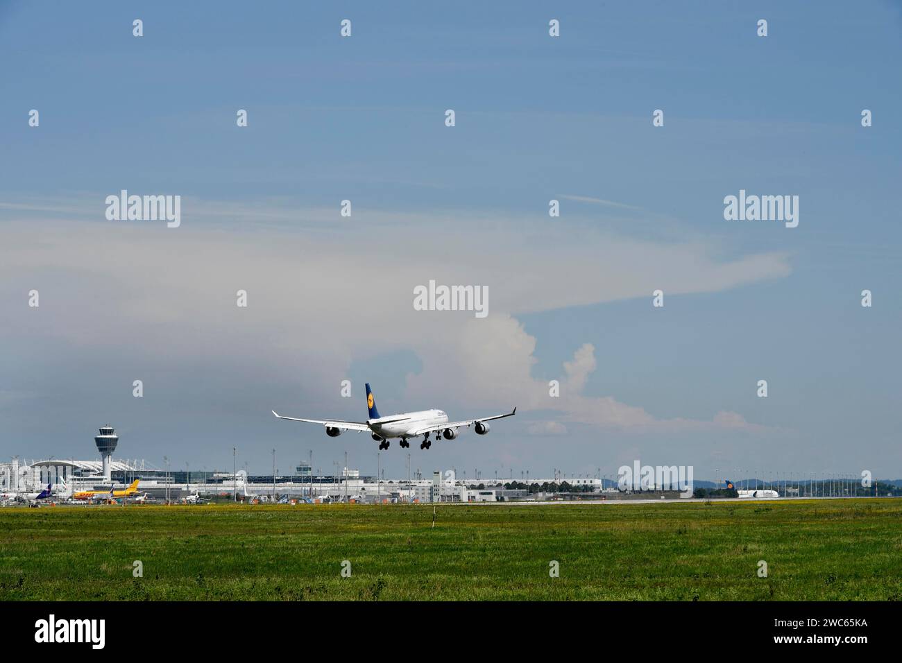 Lufthansa Airbus A340 landing on southern runway, with thundercloud and ...