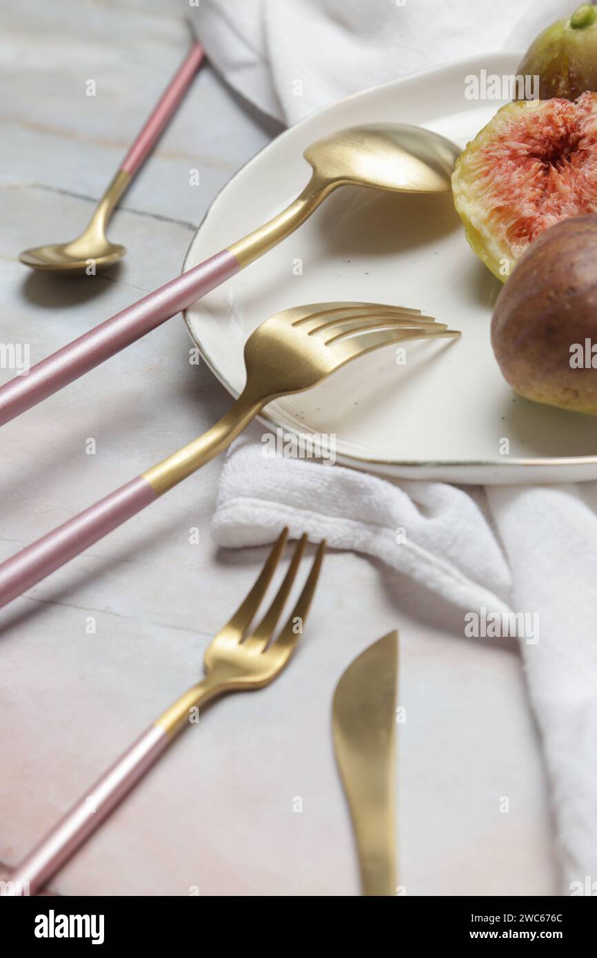 Creative shot of golden cutlery on marble table, Design concept. Modern ...