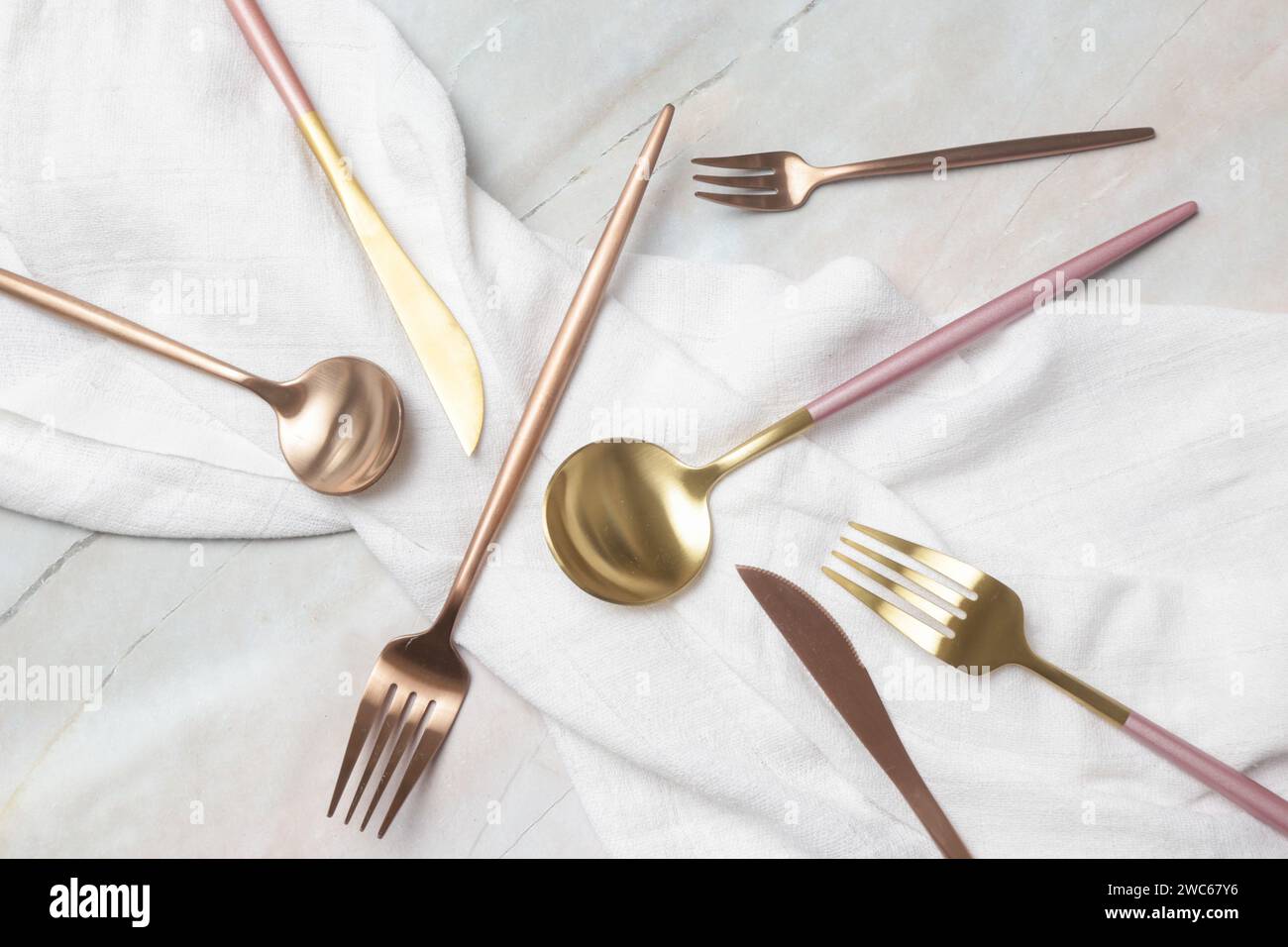 Creative shot of golden cutlery on marble table, Design concept. Modern ...