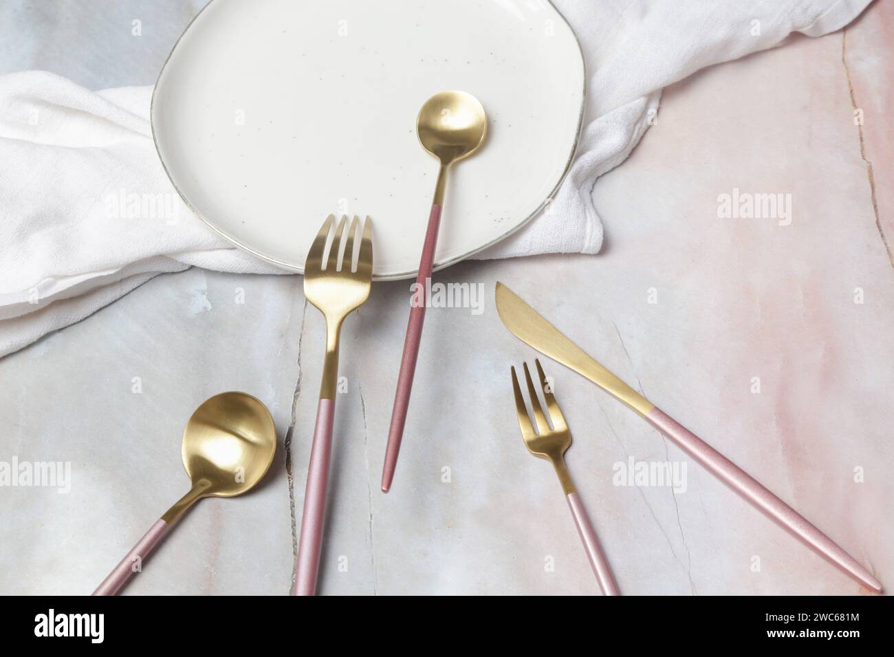 Creative shot of golden cutlery on marble table, Design concept. Modern ...