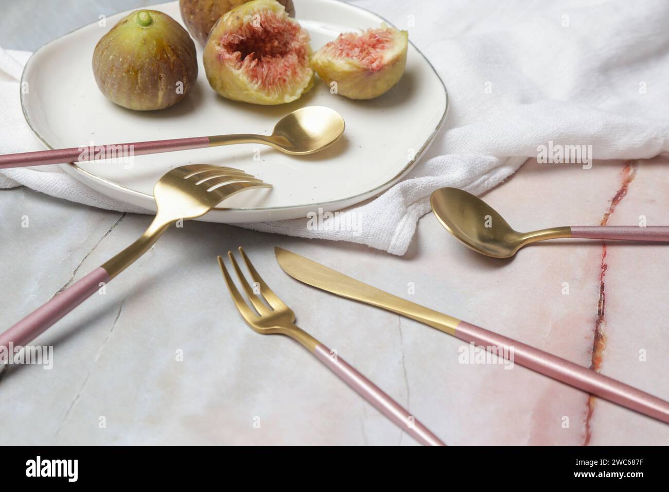 Creative shot of golden cutlery on marble table, Design concept. Modern ...