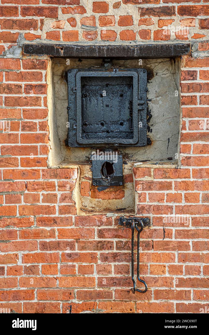 Detail of lock system of Black metal door in old building red bricks ...