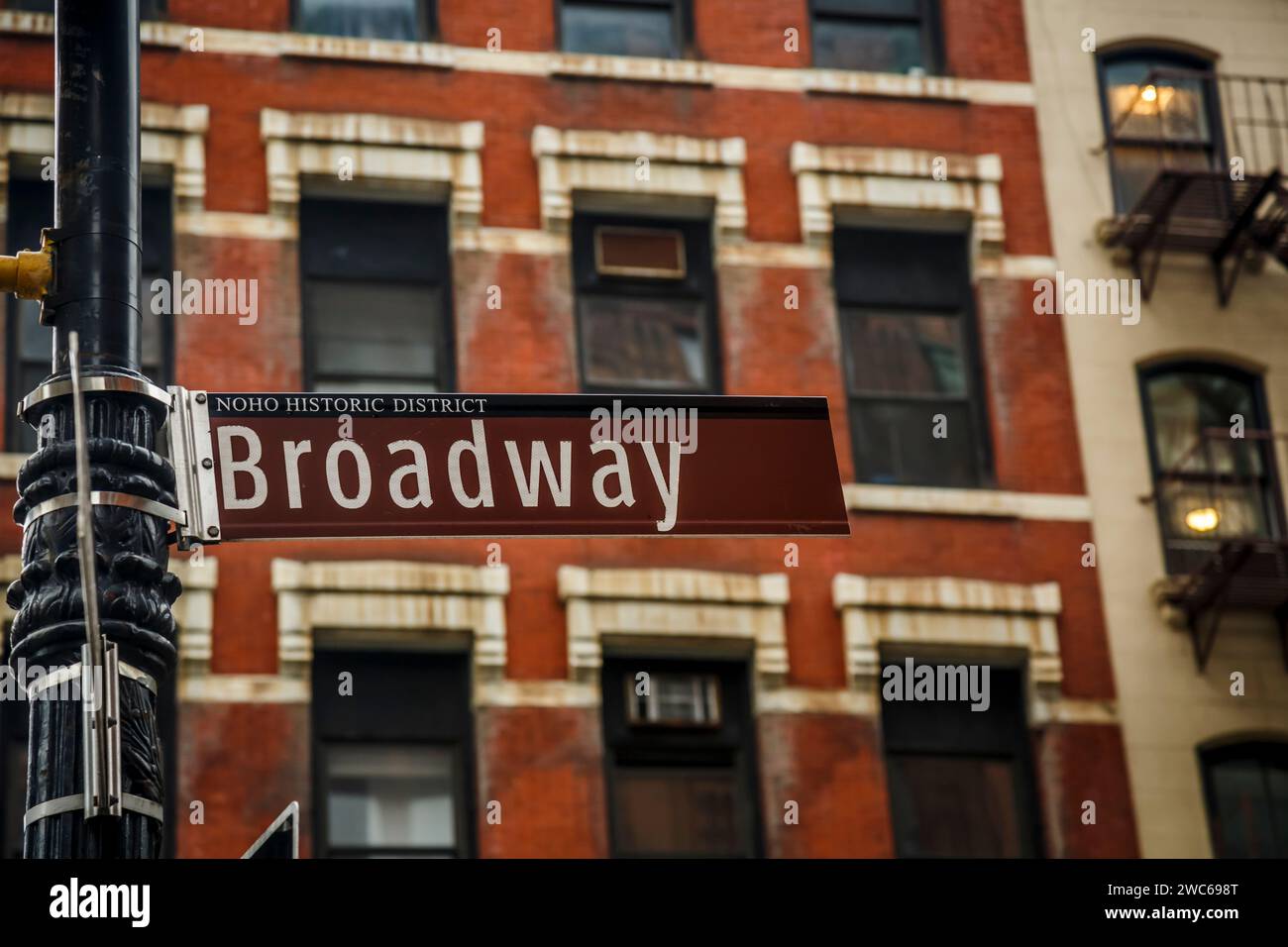 Broadway sign with red brick wall facade background in NYC, USA Stock ...