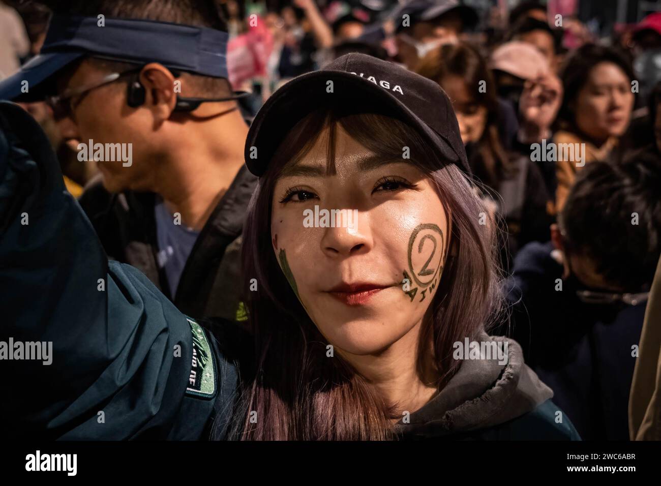 Taipei, Taiwan. 13th Jan, 2024. A DPP supporter looks on at the rally ...