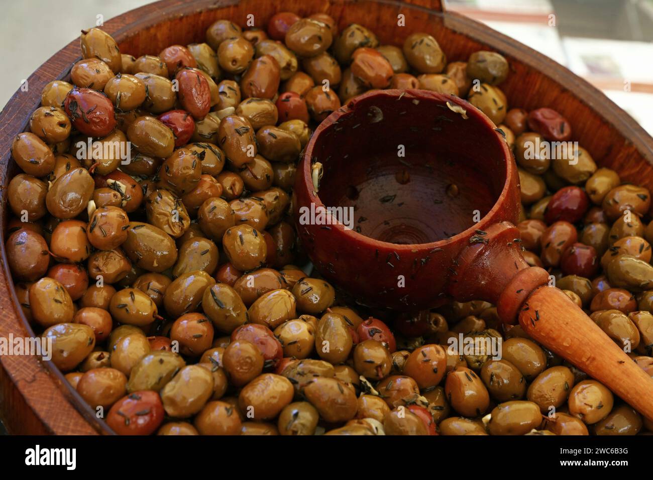 Close up traditional artisanal pickled green olives and natural wooden ...