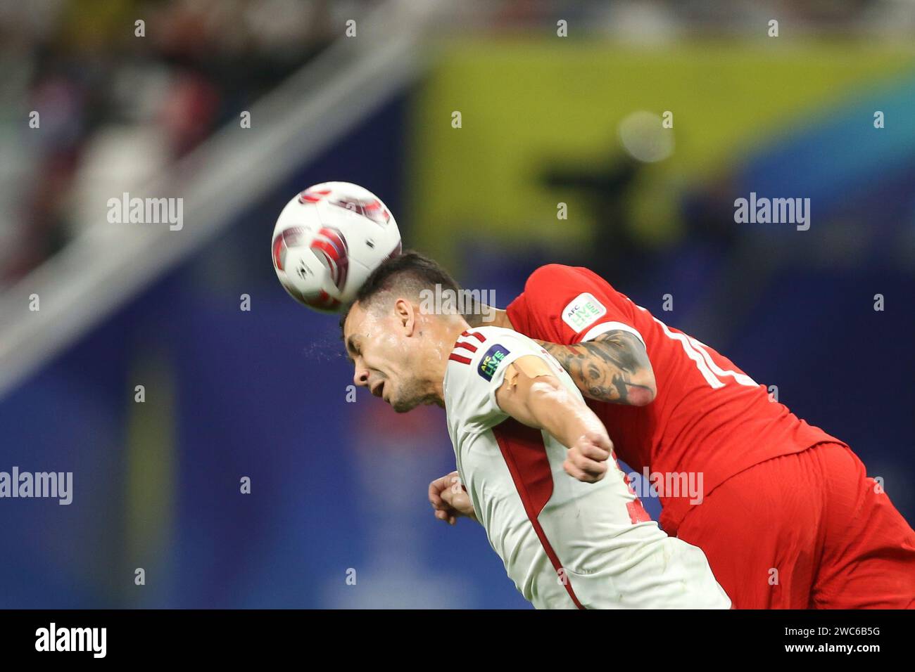 United Arab Emirates' Caio Canedo Correa, left, goes for a header ...