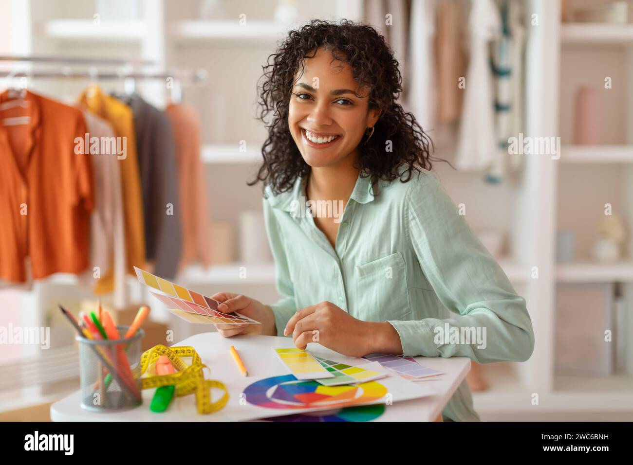 Creative designer with color swatches and charts in a studio Stock ...