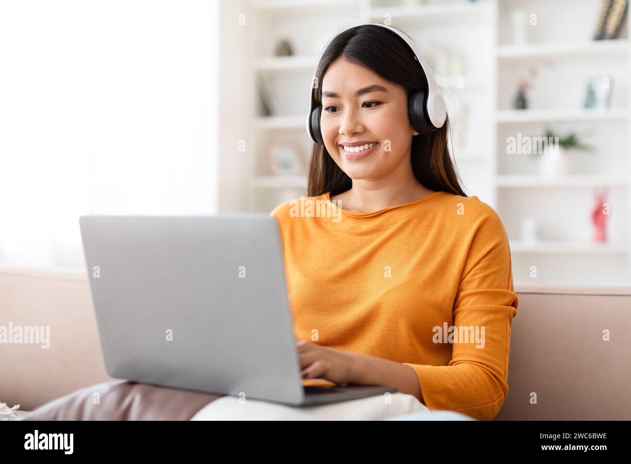 Happy young asian woman working from home Stock Photo - Alamy