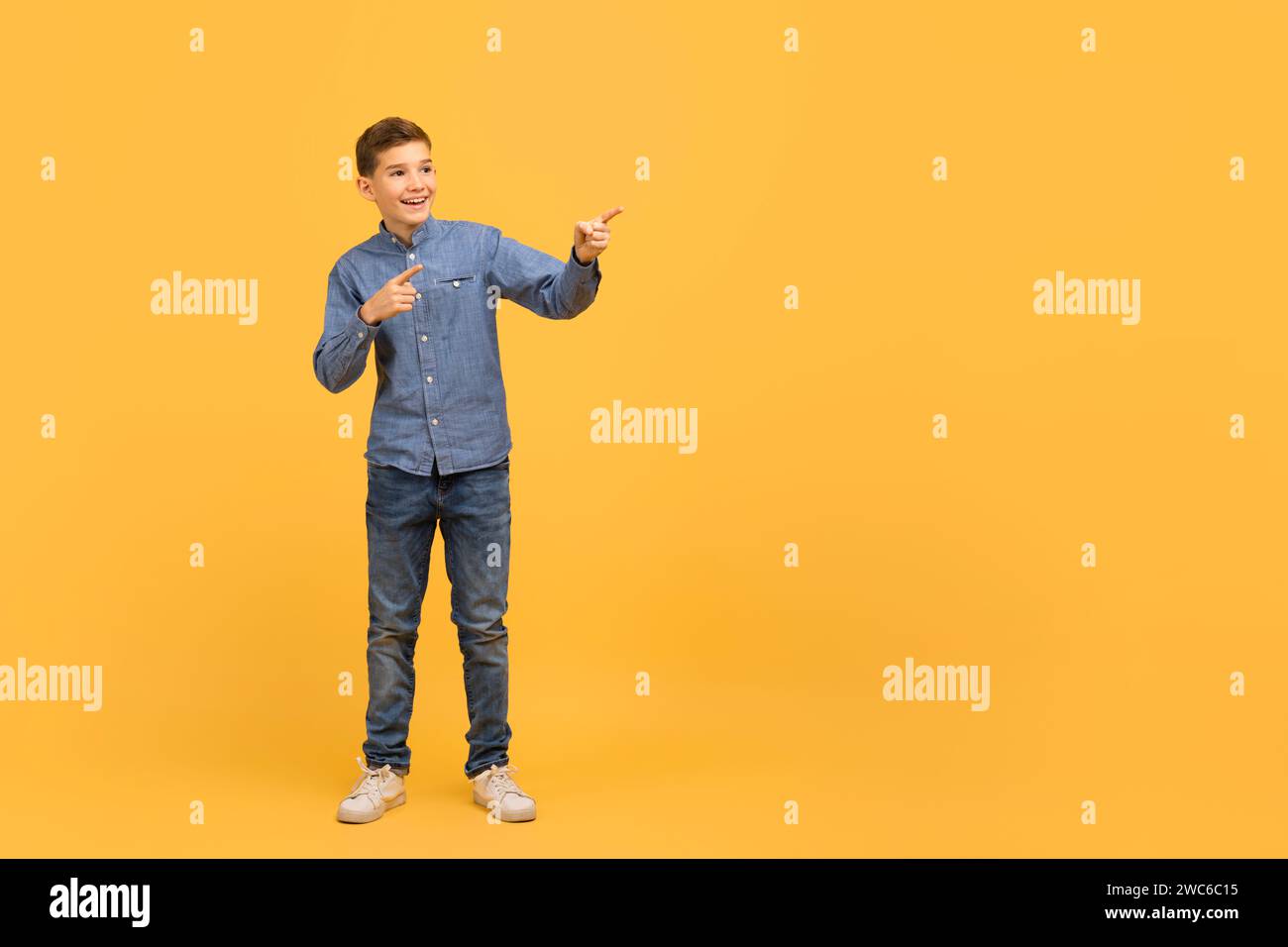 Nice Offer. Cheerful Teen Boy Pointing At Copy Space With Two Hands ...