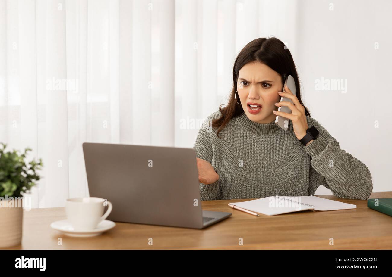 Angry young businesswoman have phone conversation with assistant Stock ...