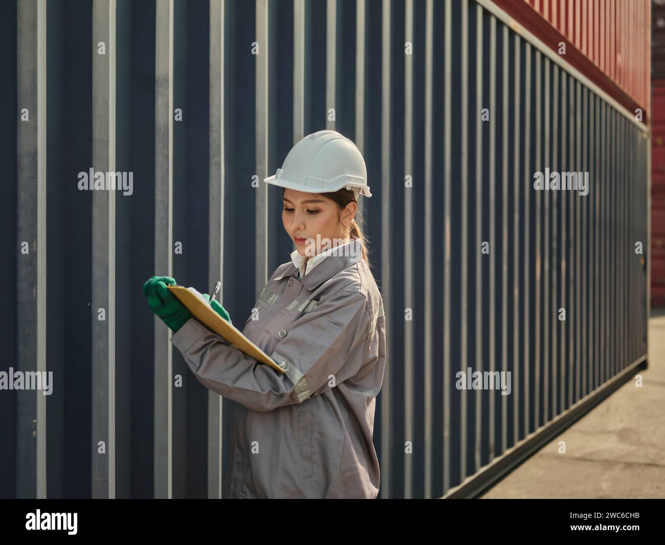 Asian woman engineer working in container port terminal. process orders ...