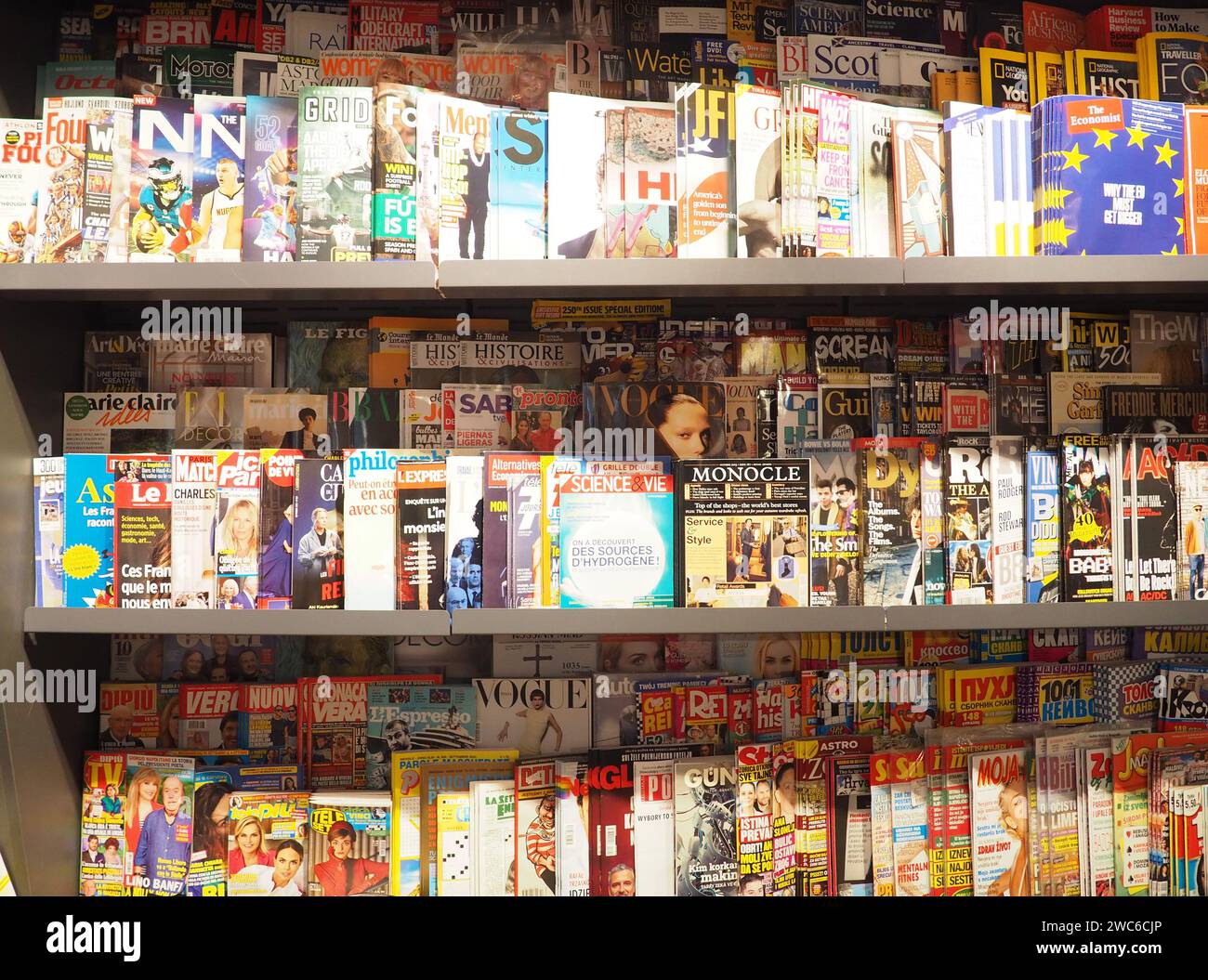 View of magazine shelf inside train station bookstore, international ...